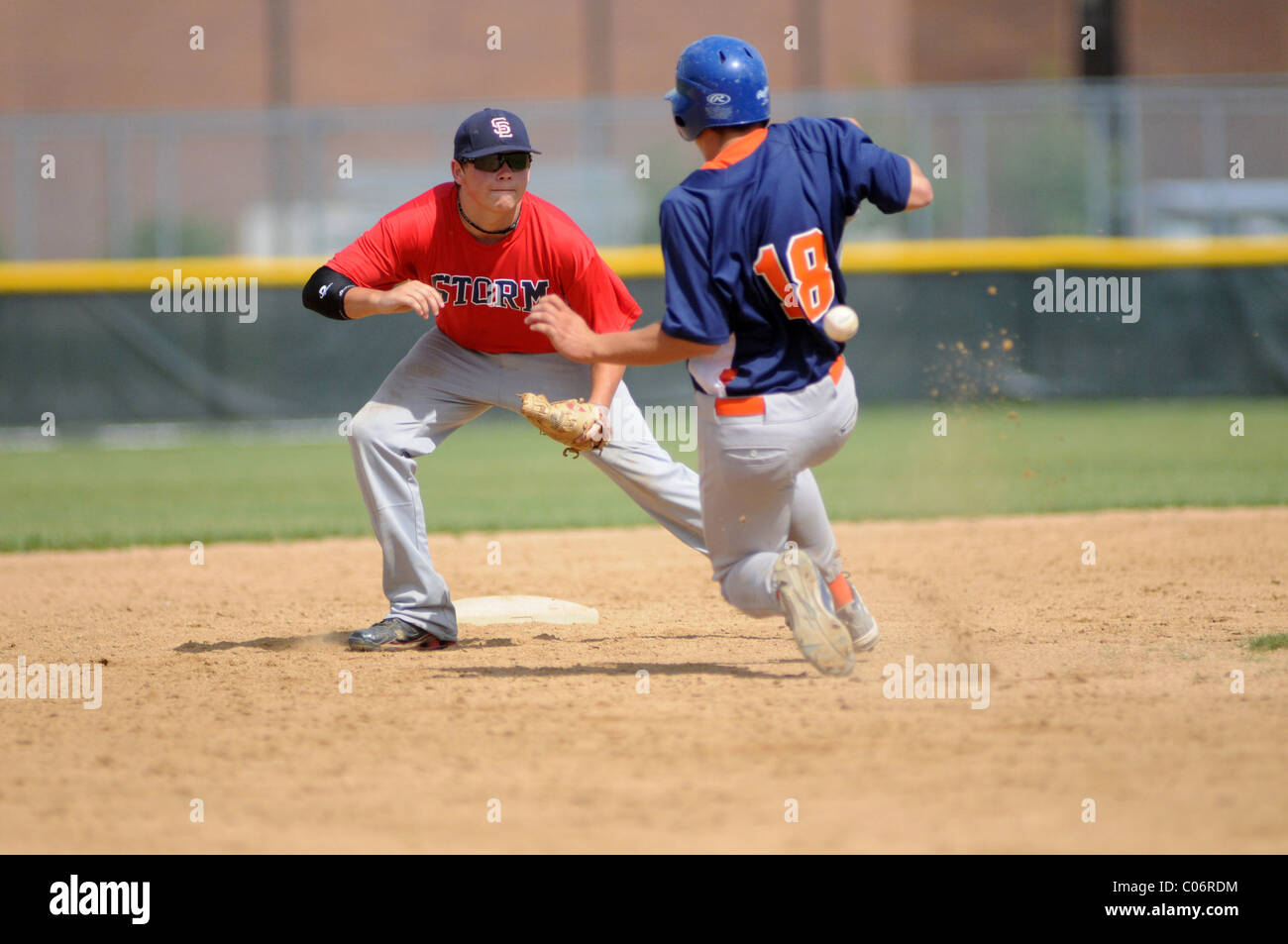High school baseball game Second baseman awaits a toss which hits the ...