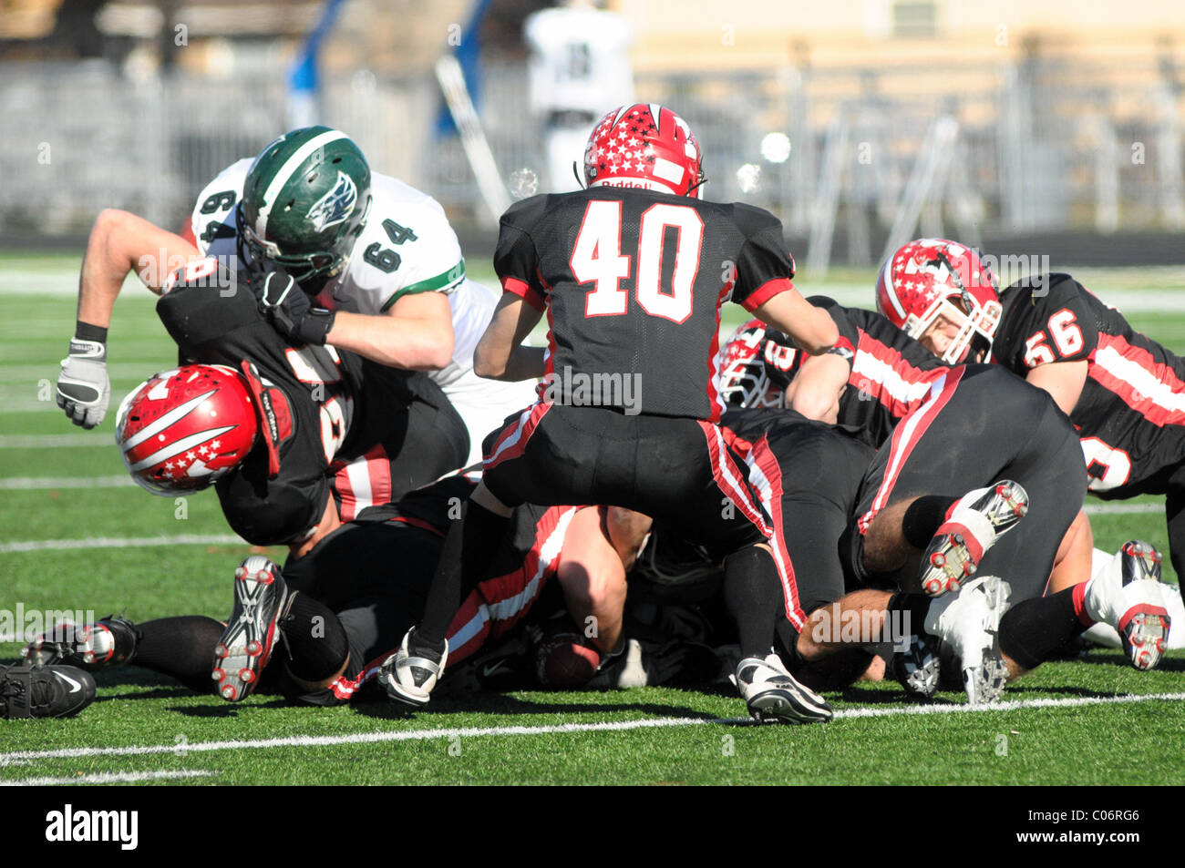 Players scrambling for football in an effort to recover a fumble. USA ...
