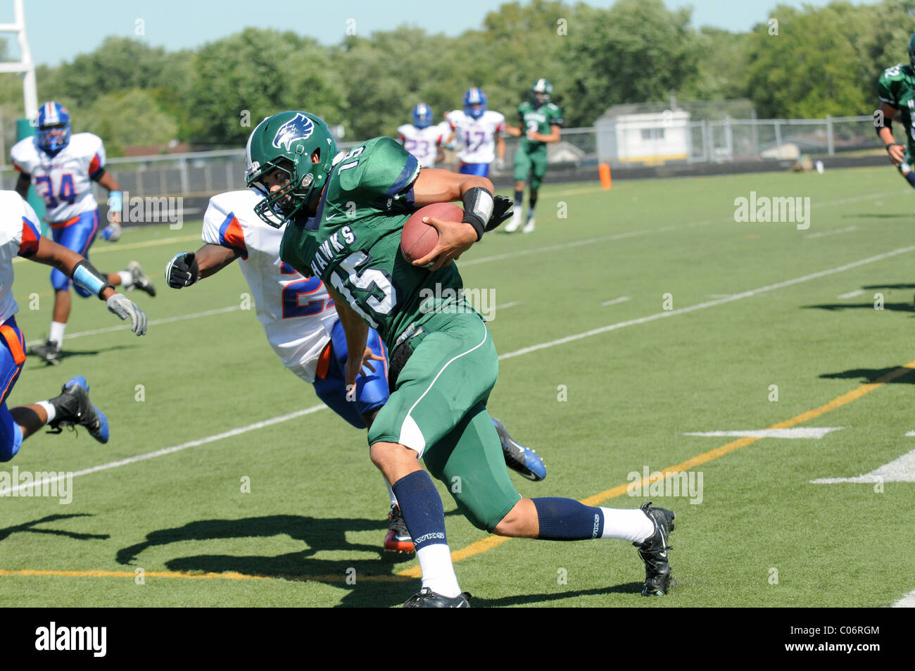 High school quarterback running with the ball during a designed play ...