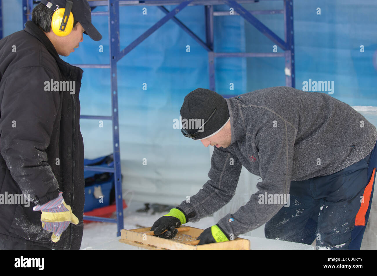 Teams of professional ice carvers work together to build massive ice ...