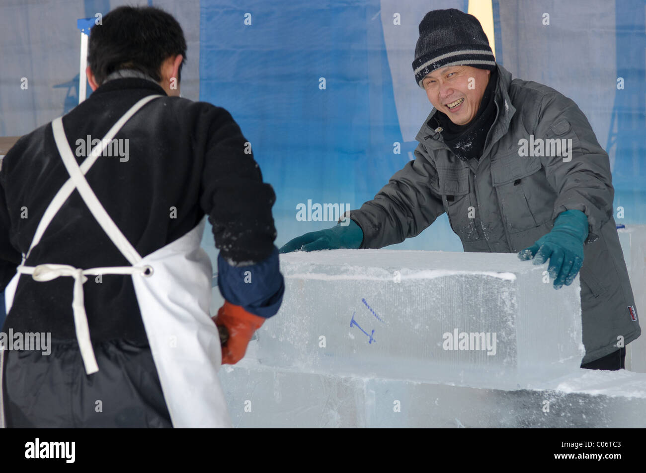 Teams of professional ice carvers work together to build massive ice ...