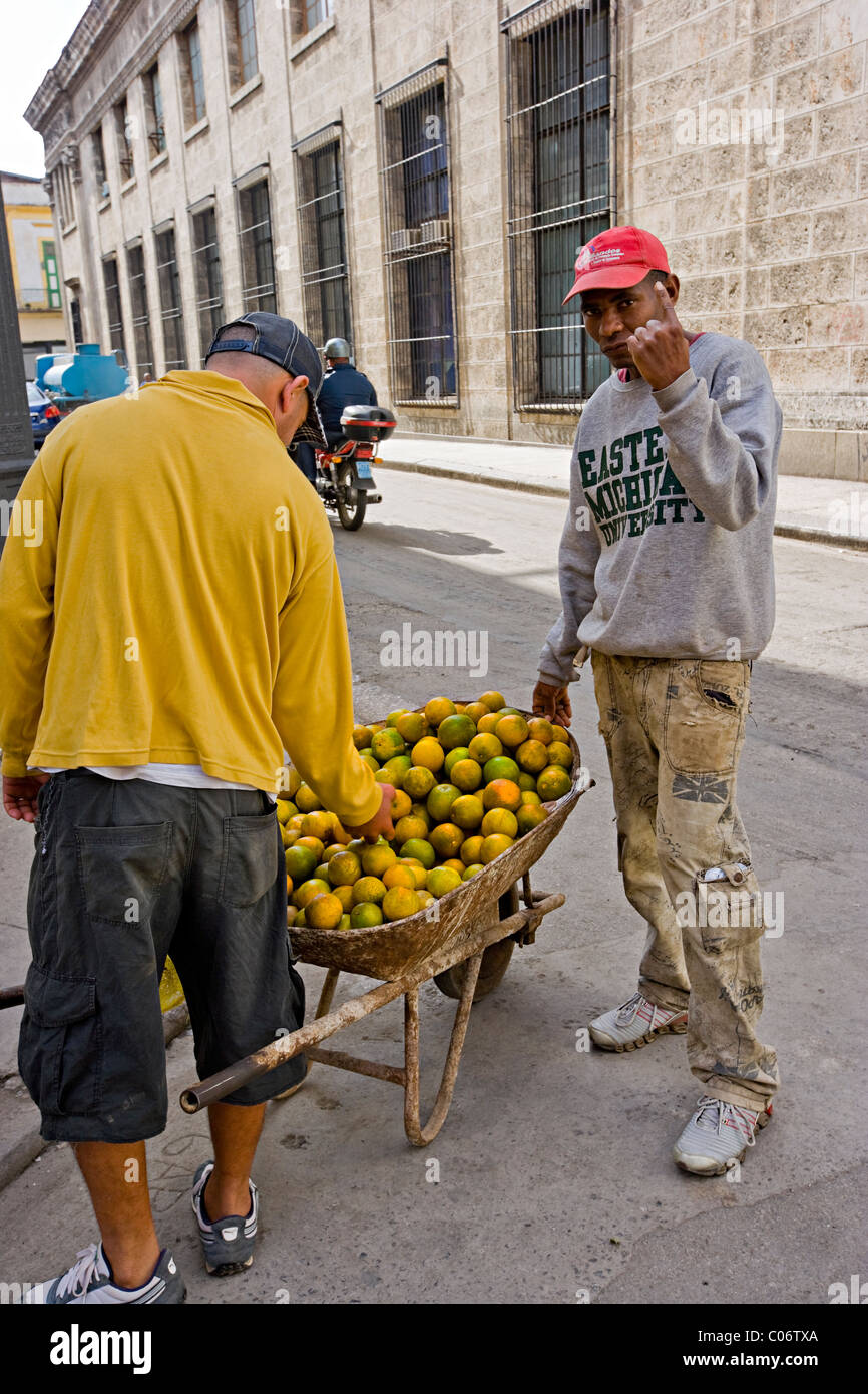 Two men selling oranges out of a wheelbarrow in Cuba Havana Stock Photo ...