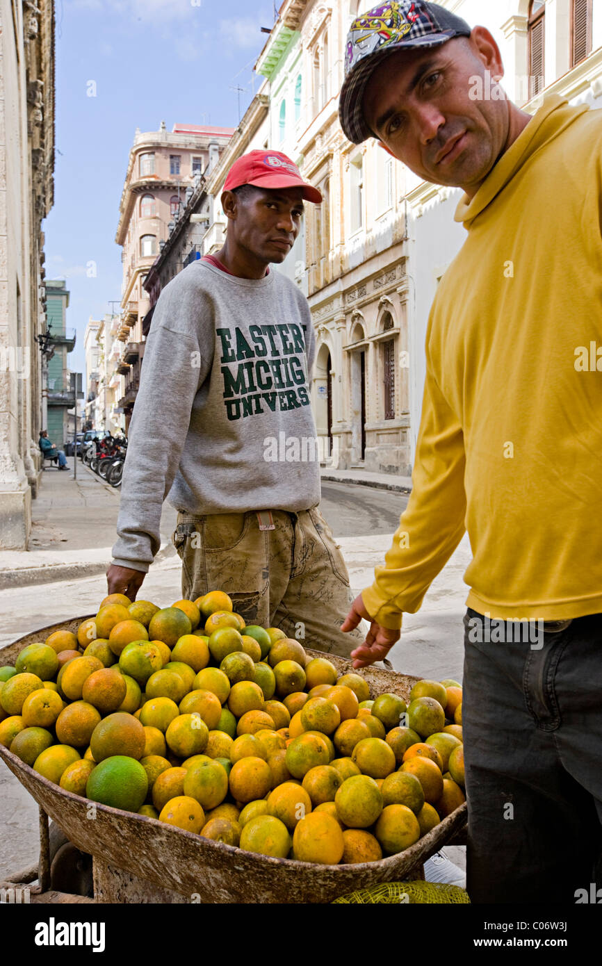 Two men selling oranges out of a wheelbarrow in Cuba Havana Stock Photo ...