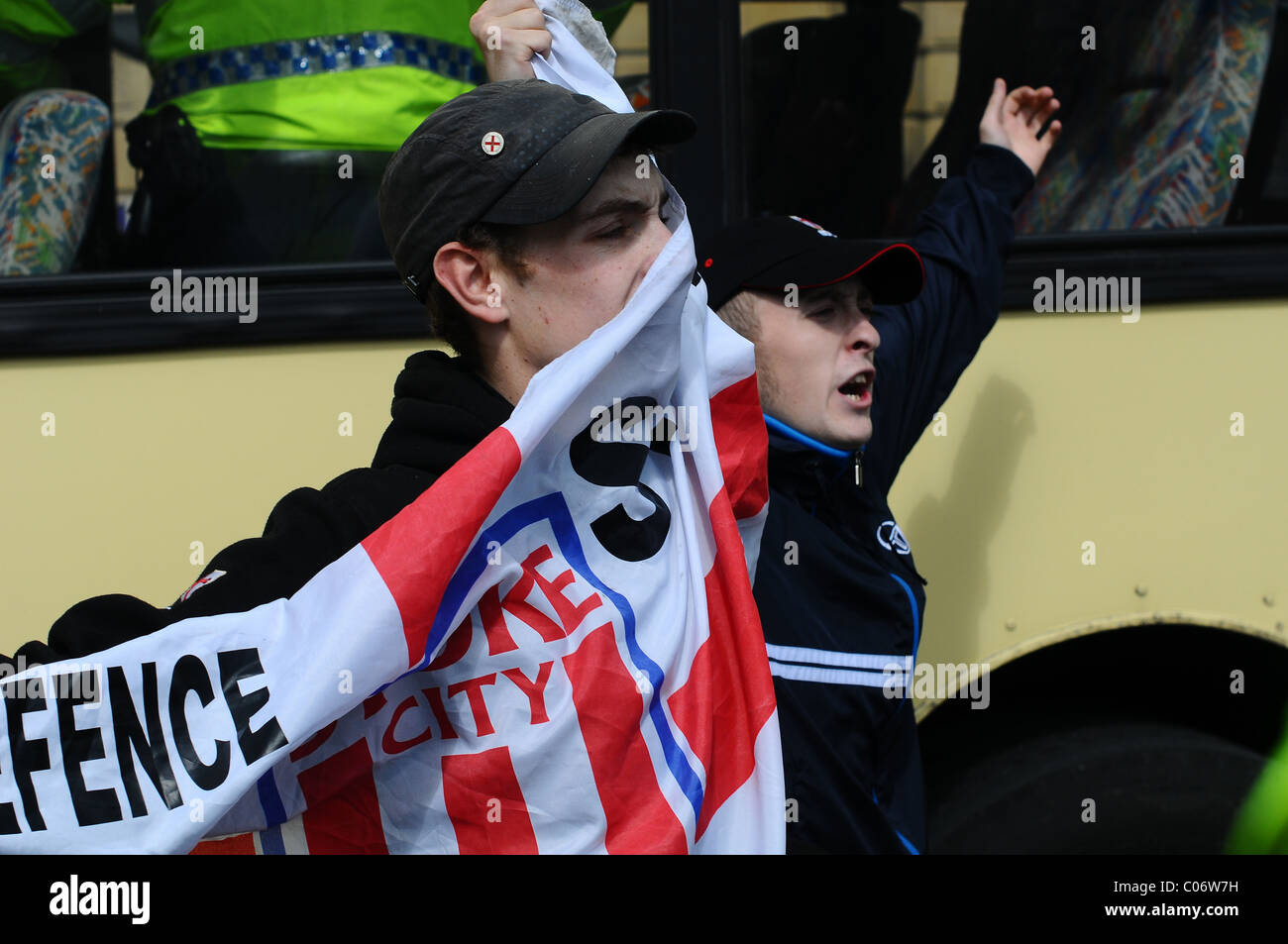 EDL supporters hold the flag high and sing England songs Stock Photo ...
