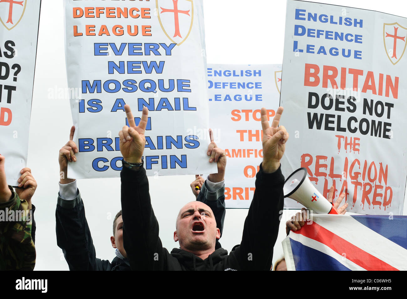 Proud EDL supporters sing England songs with there hands in the air and ...