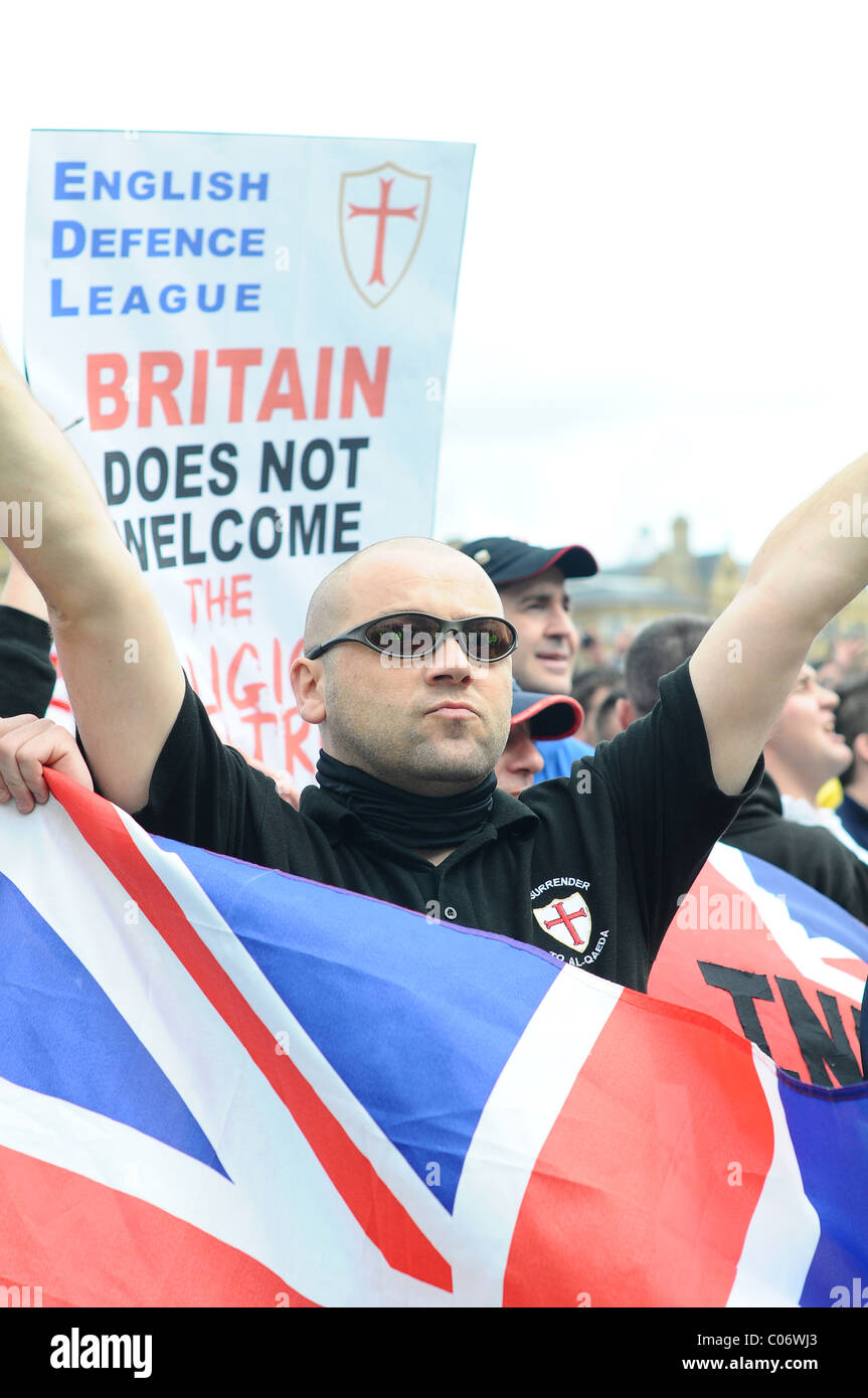 EDL supporter stands proud with glasses on, in front of an England flag ...