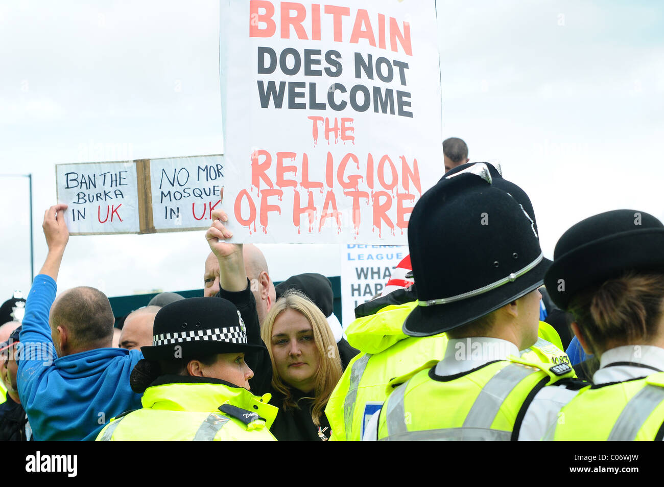 Police keep back the EDL supporters holding banners with the police ...