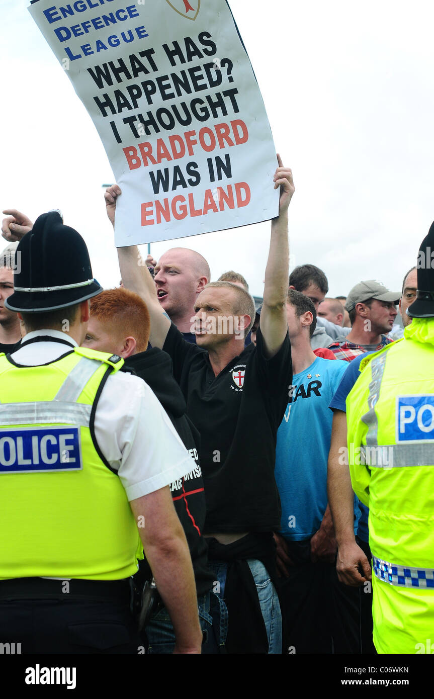 Police keep back the EDL supporters with the police line of officers ...