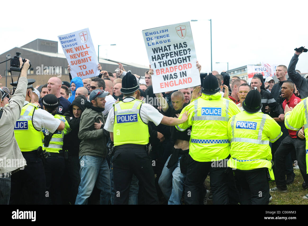 Police keep back the EDL supporters with the police line of officers ...