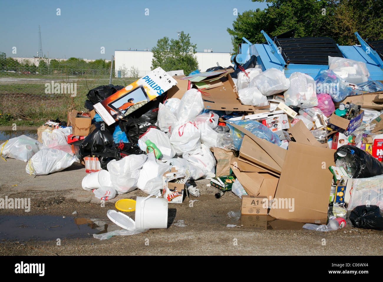 Recycle center drop off container overflows with bags and boxes of ...