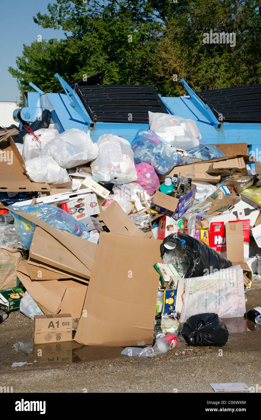 Recycle center drop off container overflows with bags and boxes of ...