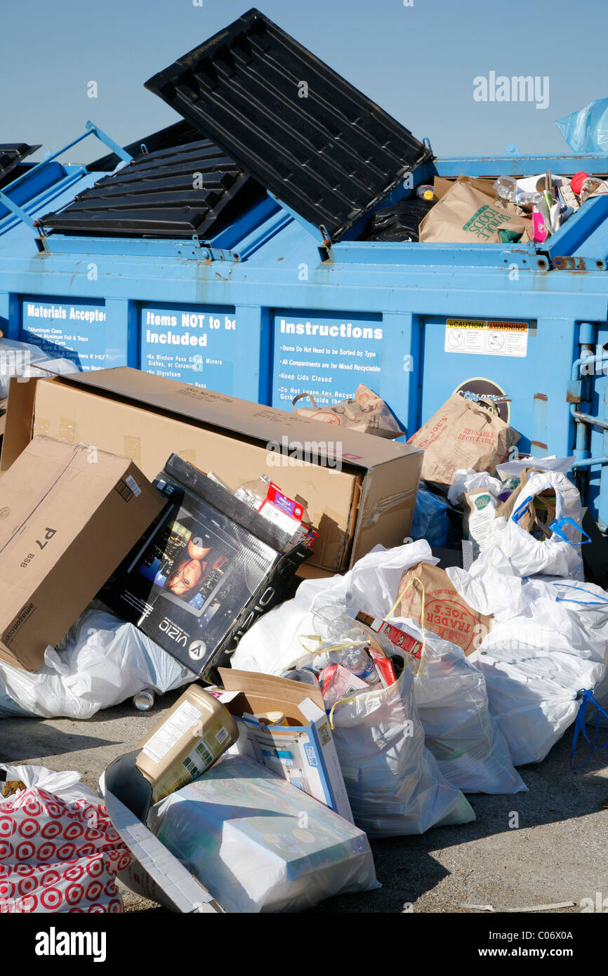 Recycle center drop off container overflows with bags and boxes of ... Recycle center drop off container overflows with bags and boxes of ...