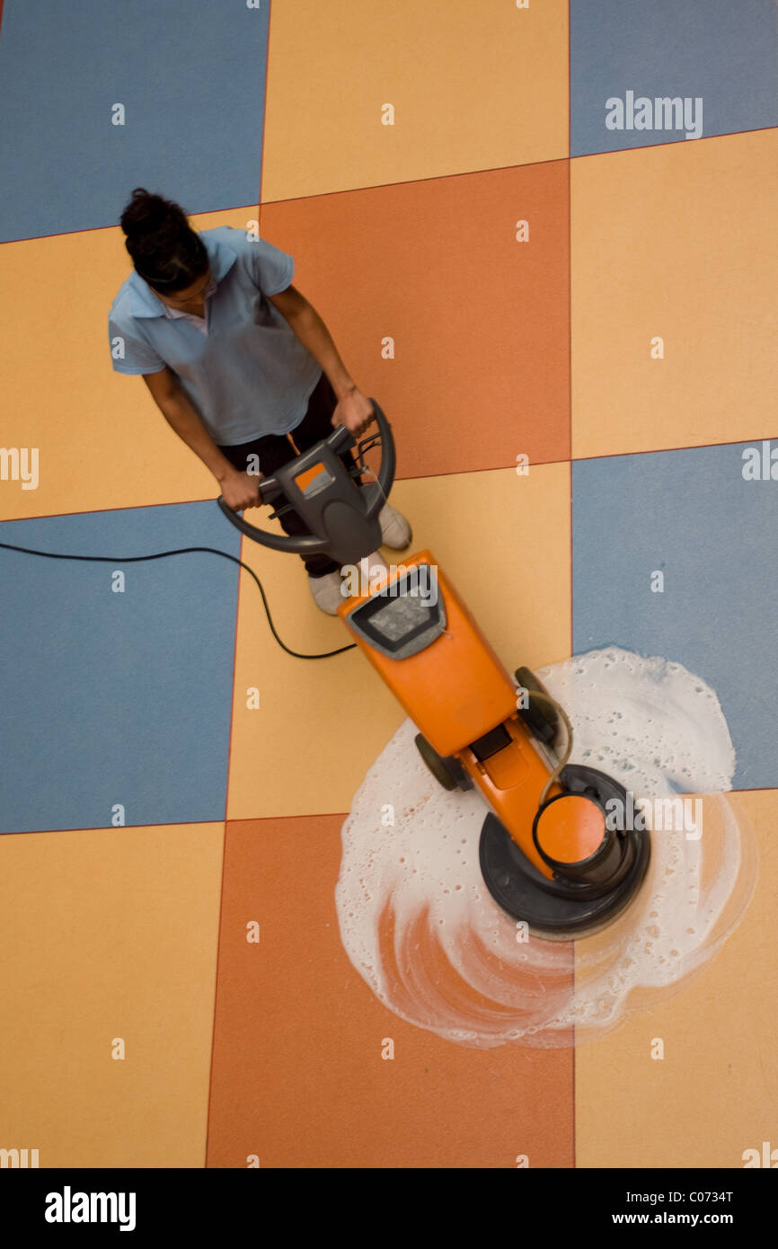 A worker is cleaning the floor with machine Stock Photo - Alamy
