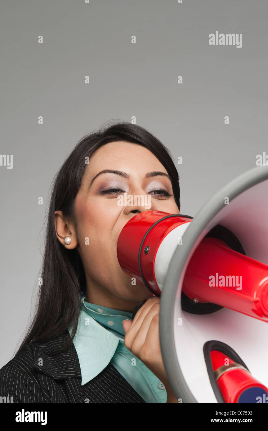 Businesswoman shouting into a megaphone Stock Photo - Alamy