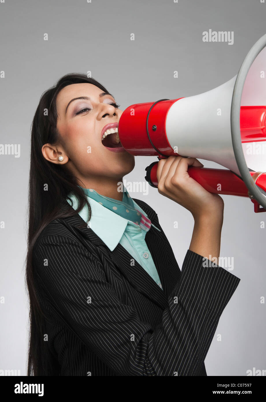 Businesswoman shouting into a megaphone Stock Photo - Alamy