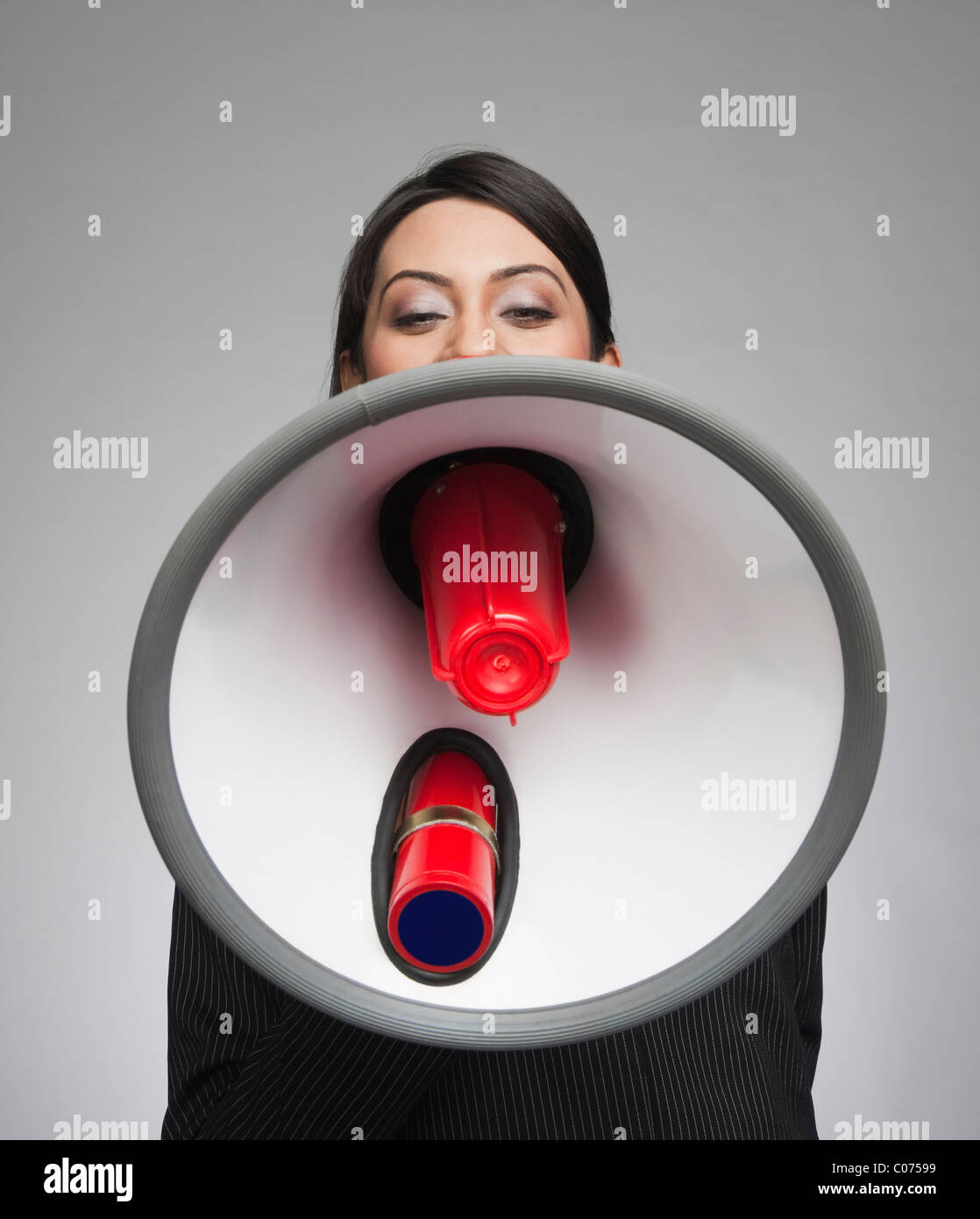 Businesswoman shouting into a megaphone Stock Photo - Alamy