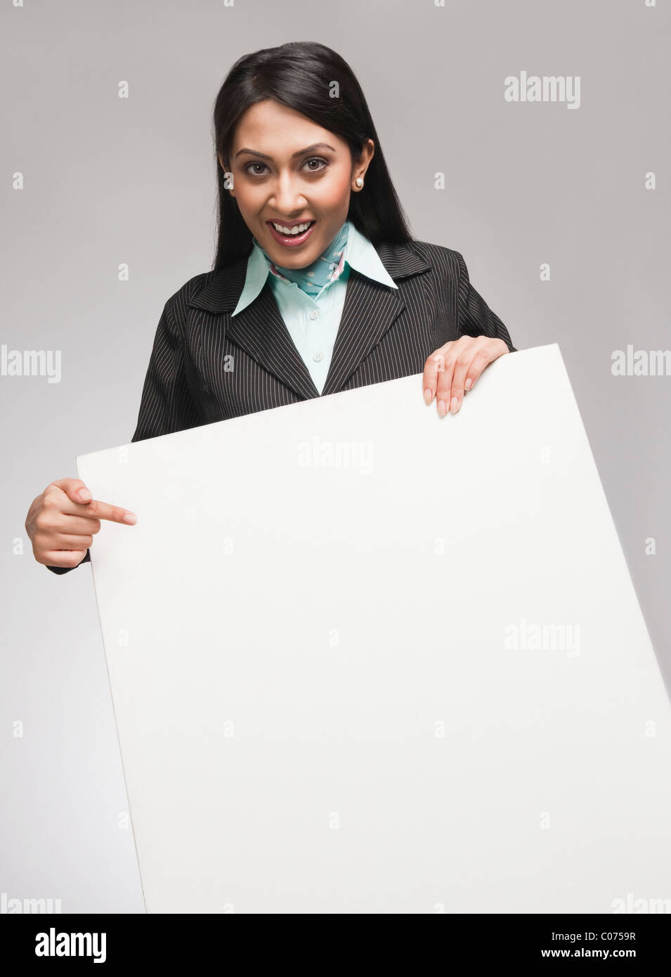 Businesswoman showing a placard and smiling Stock Photo - Alamy