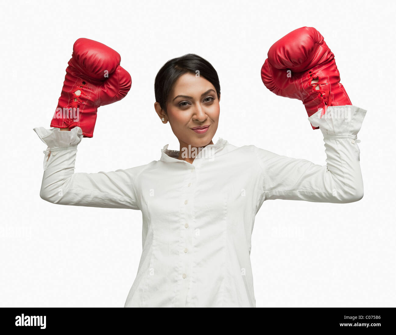Businesswoman in boxing gloves cheering with arms raised Stock Photo ...