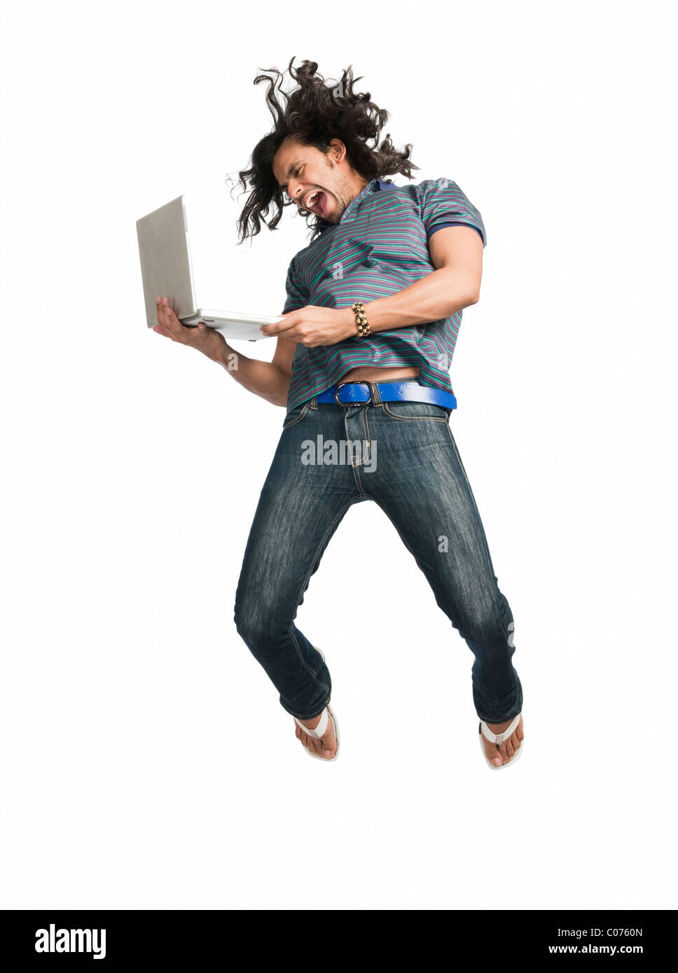 Man jumping while using a laptop Stock Photo - Alamy