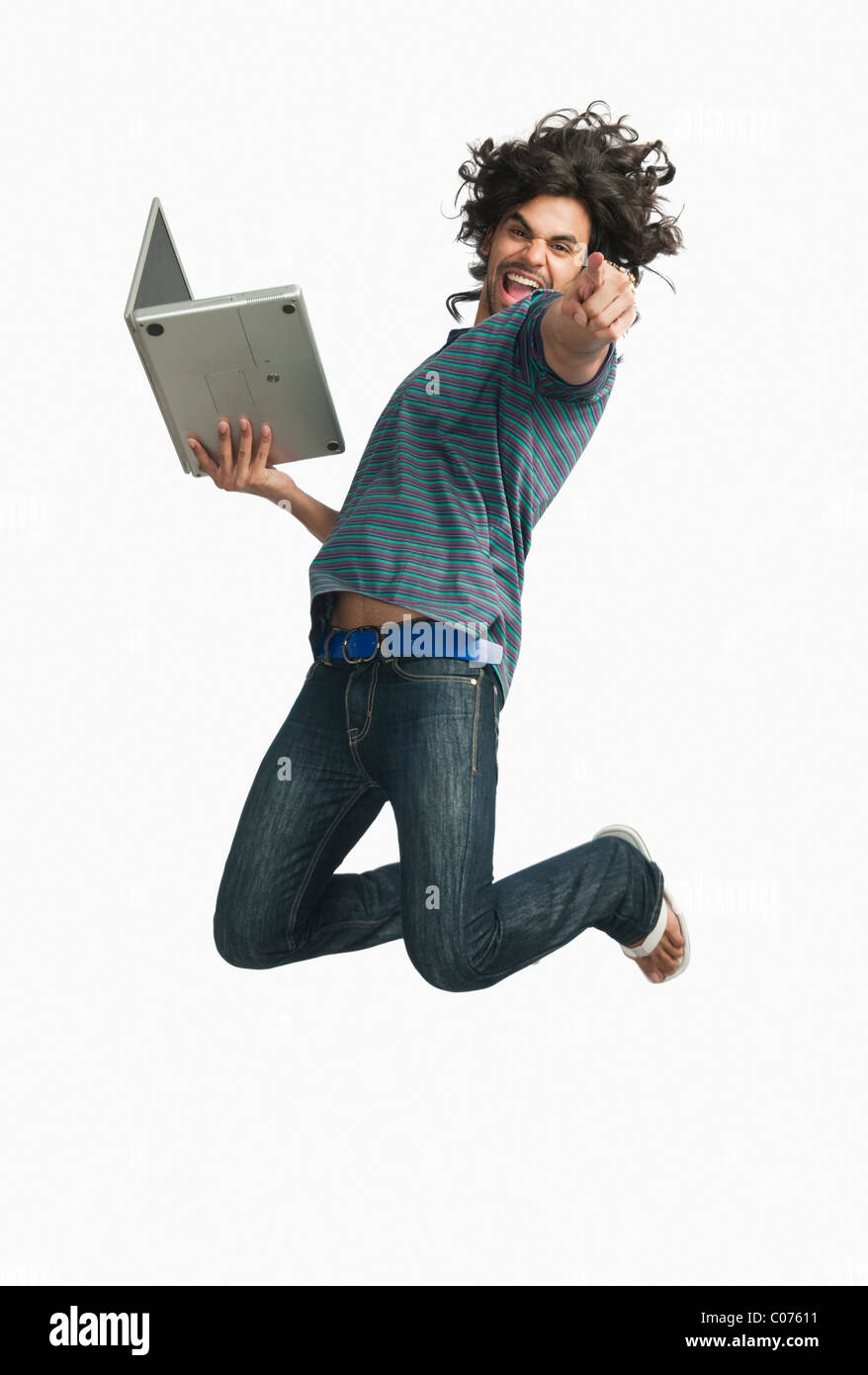 Man jumping while using a laptop Stock Photo - Alamy