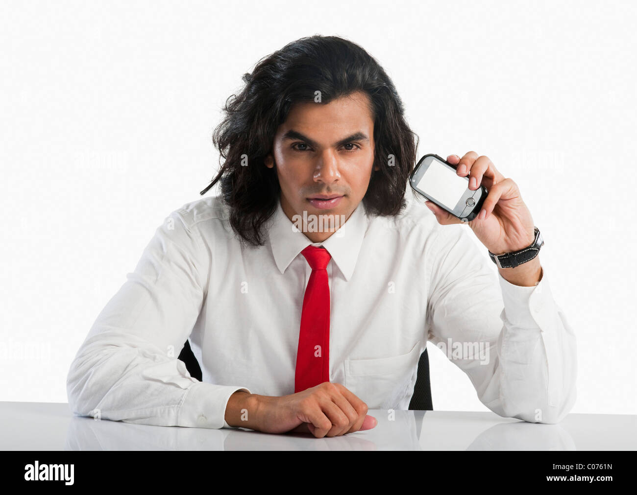 Portrait of a businessman showing a mobile phone Stock Photo - Alamy