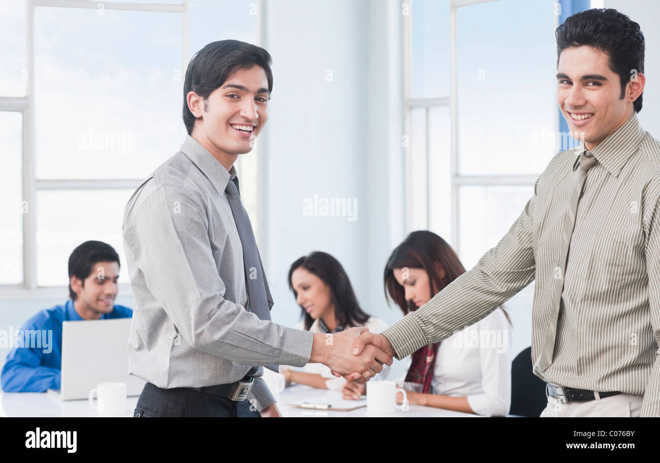 Two businessmen shaking hands Stock Photo - Alamy
