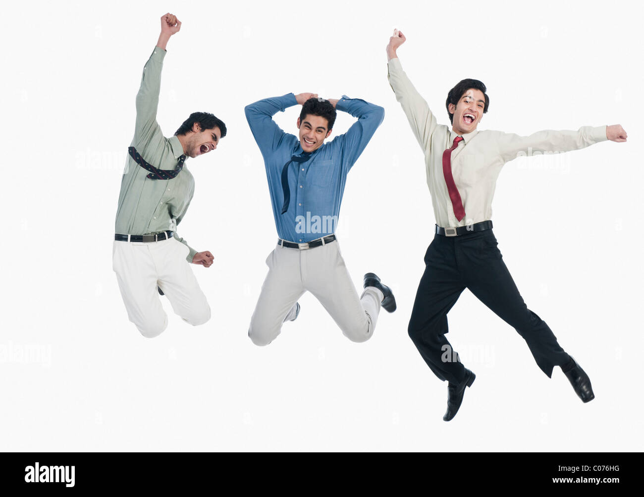 Three businessmen jumping Stock Photo - Alamy