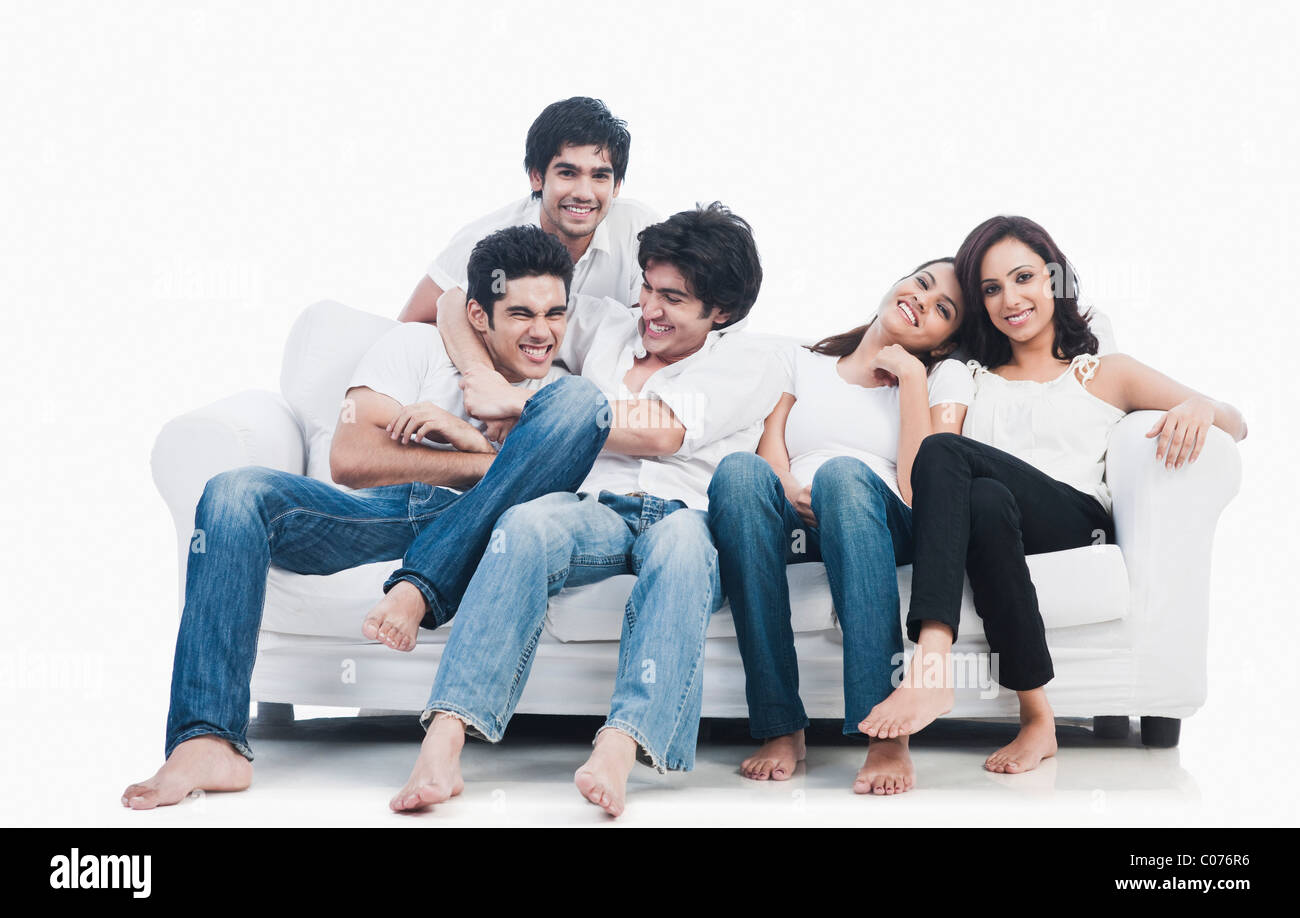 Friends having fun on a couch Stock Photo - Alamy