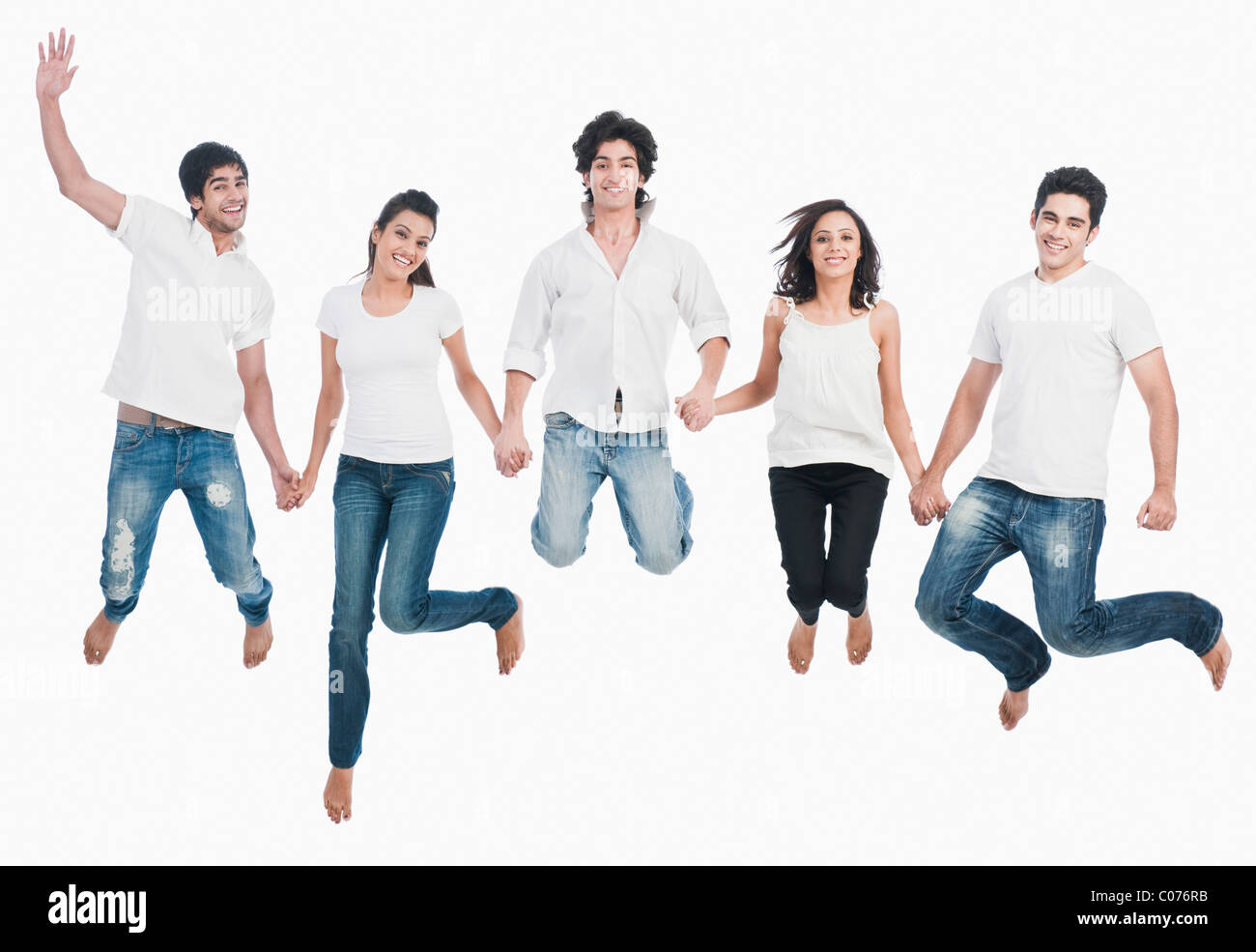 Friends jumping together Stock Photo - Alamy