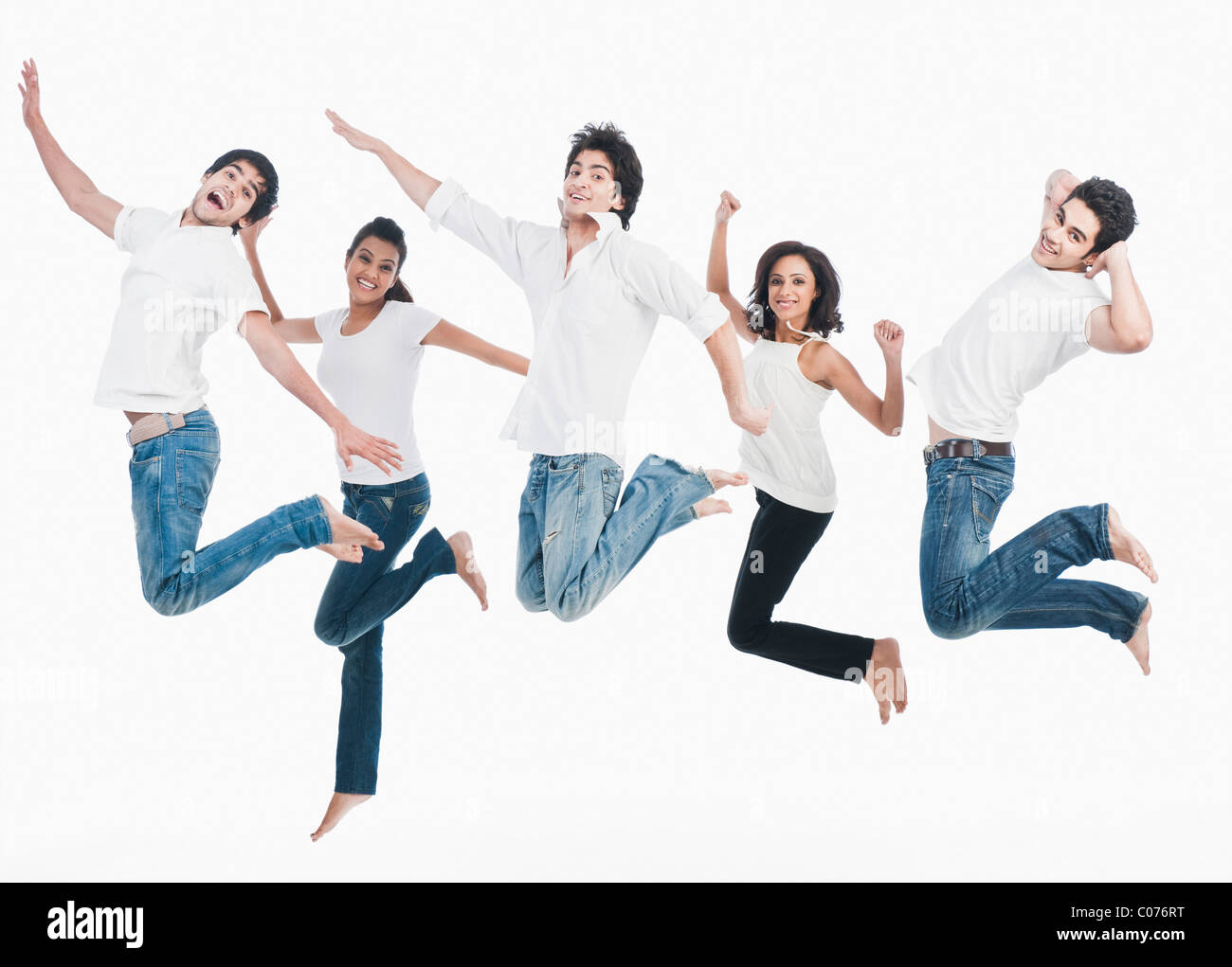 Friends jumping together Stock Photo - Alamy