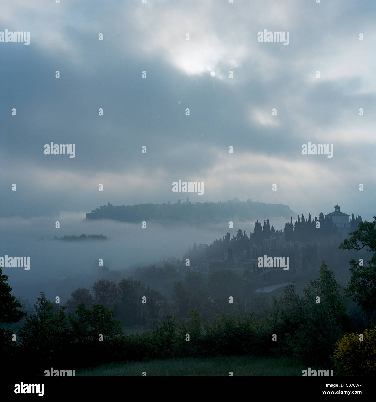 The outlines of the city in early ground fog, Orvieto, Umbria, Italy ...