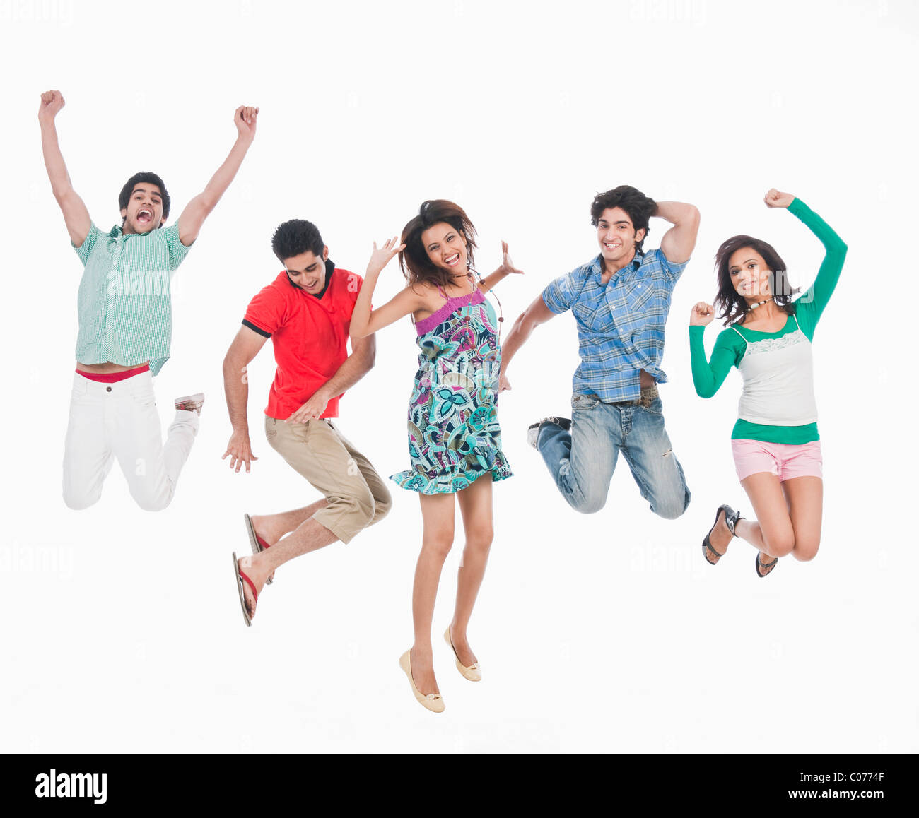 Group of friends jumping Stock Photo - Alamy