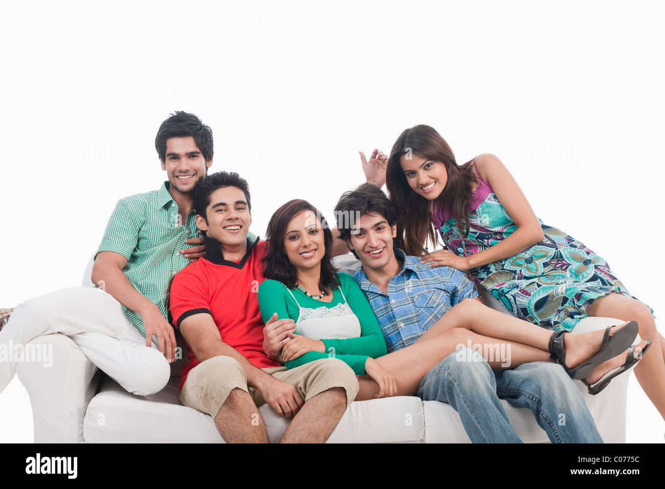 Portrait of friends sitting on couch Stock Photo - Alamy