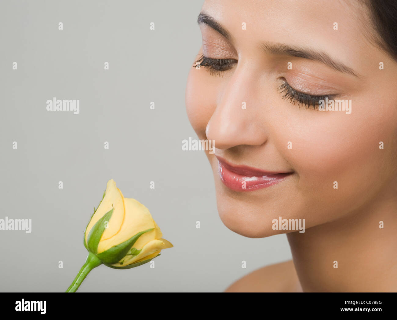 Indian young woman smelling flower hi-res stock photography and images ...