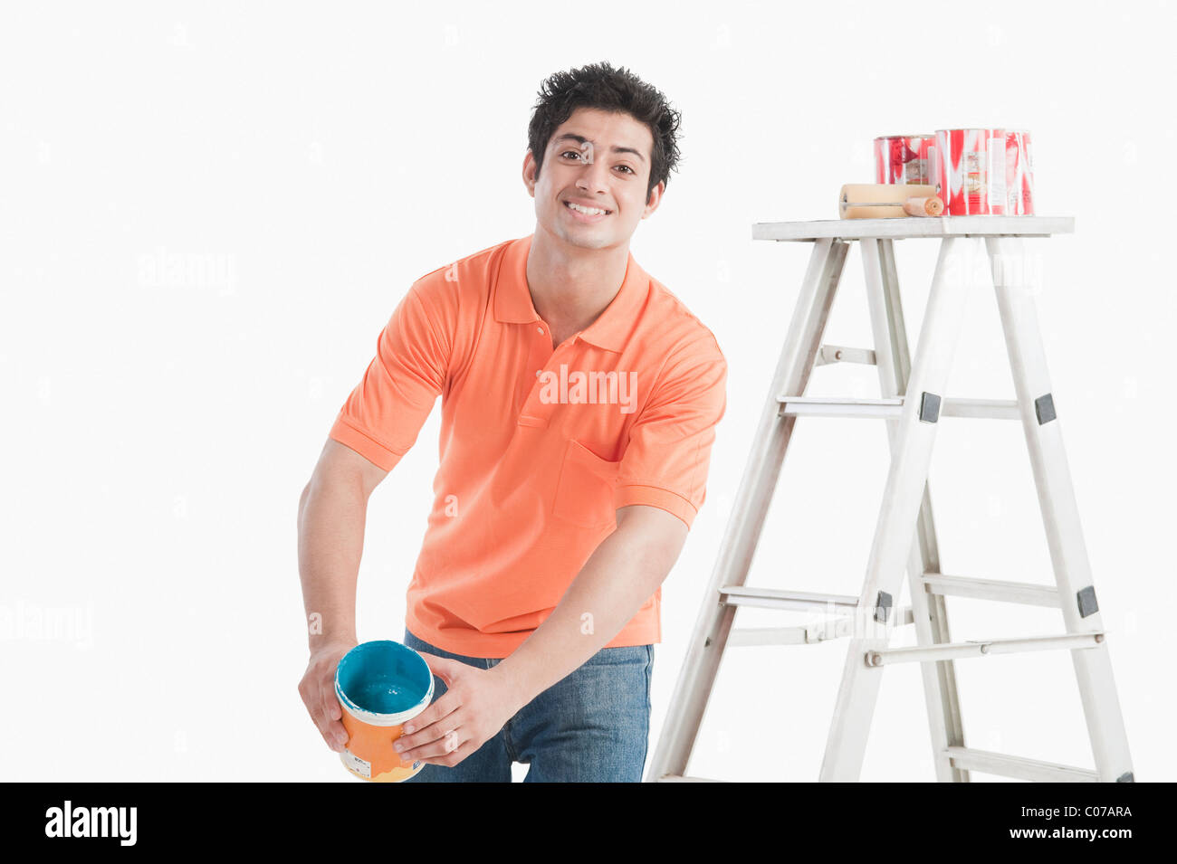 Man orange shirt holding Cut Out Stock Images & Pictures - Alamy