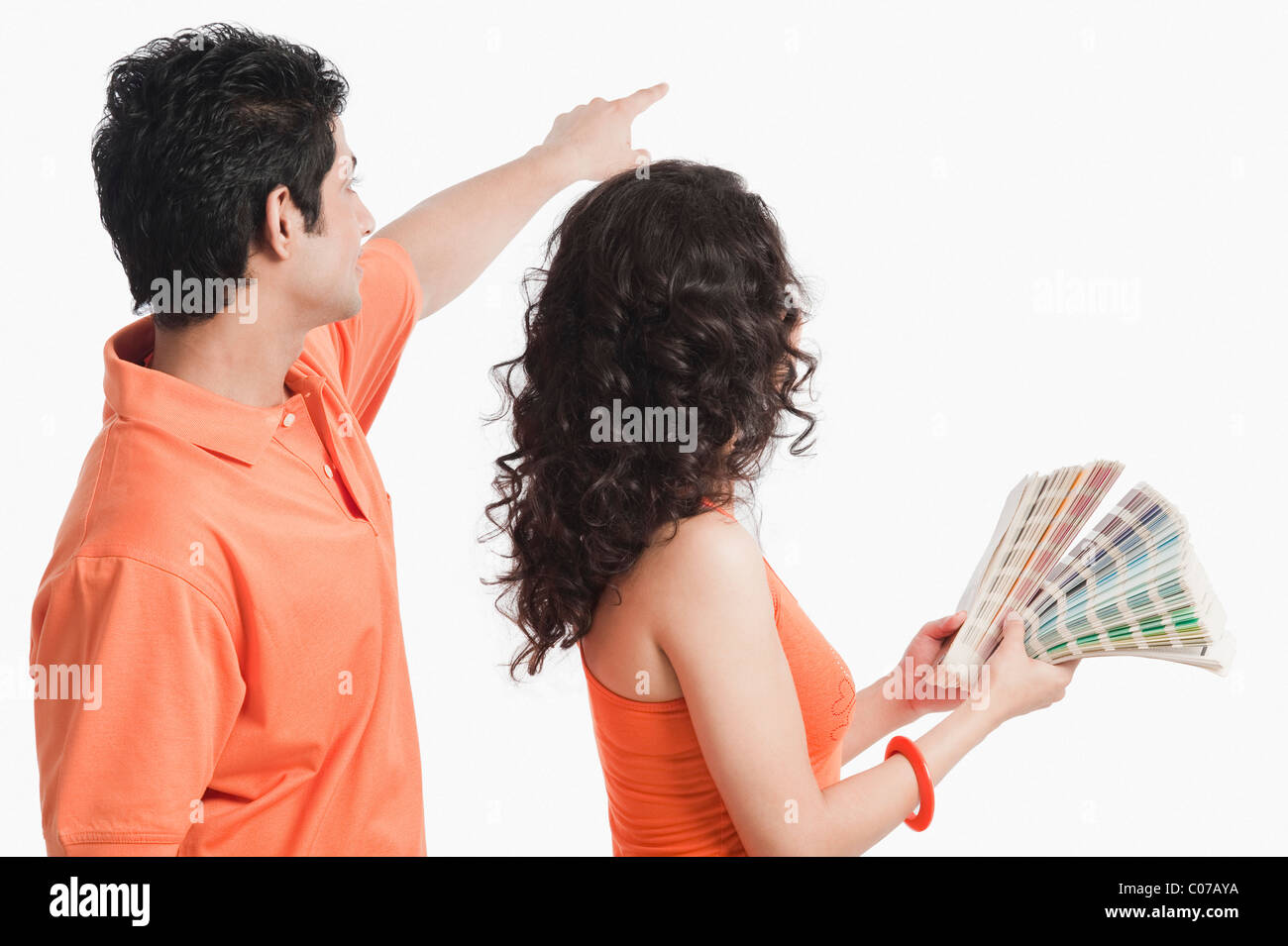 Couple choosing color from color swatches for their house Stock Photo ...