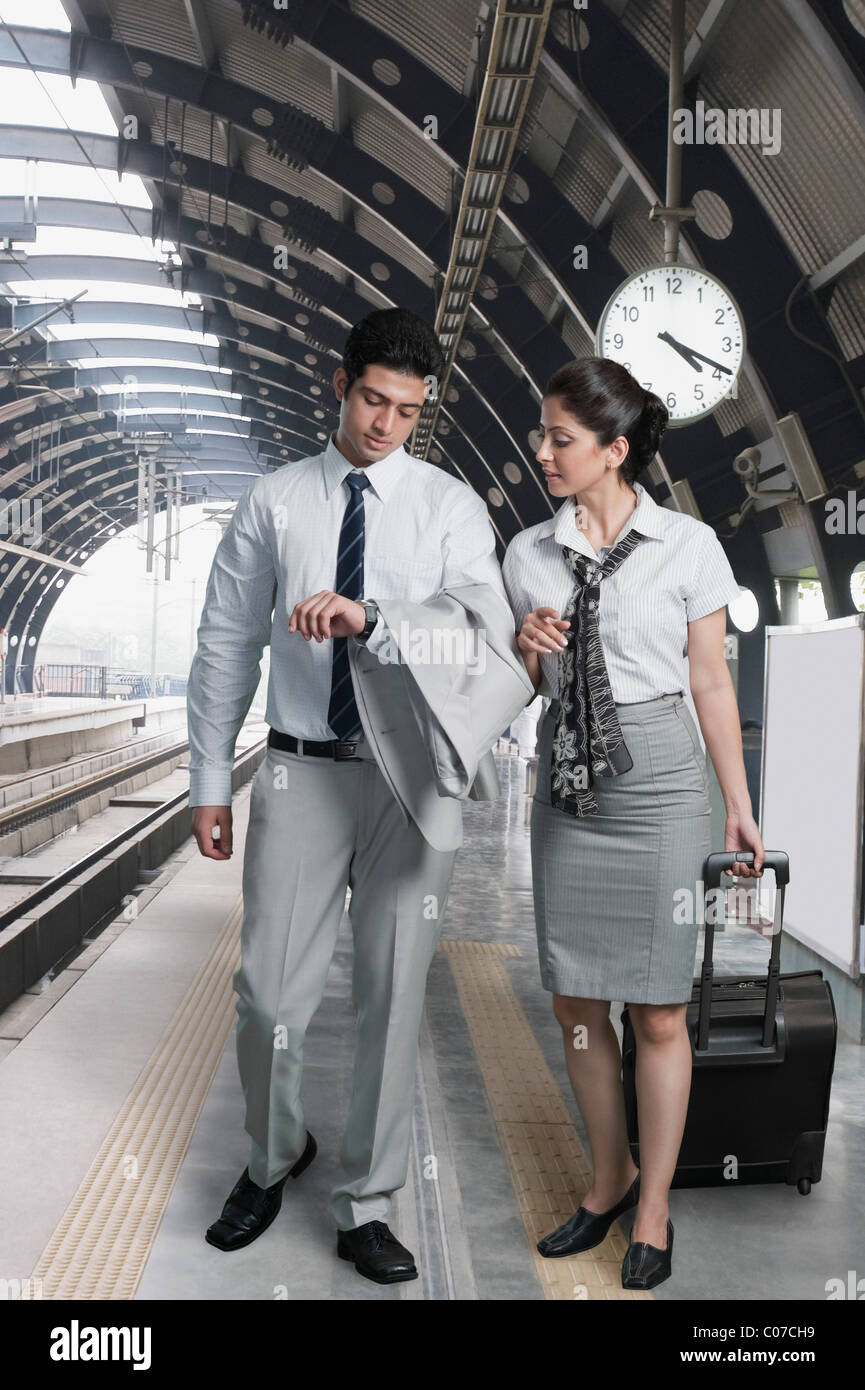 Business couple at a subway station Stock Photo - Alamy