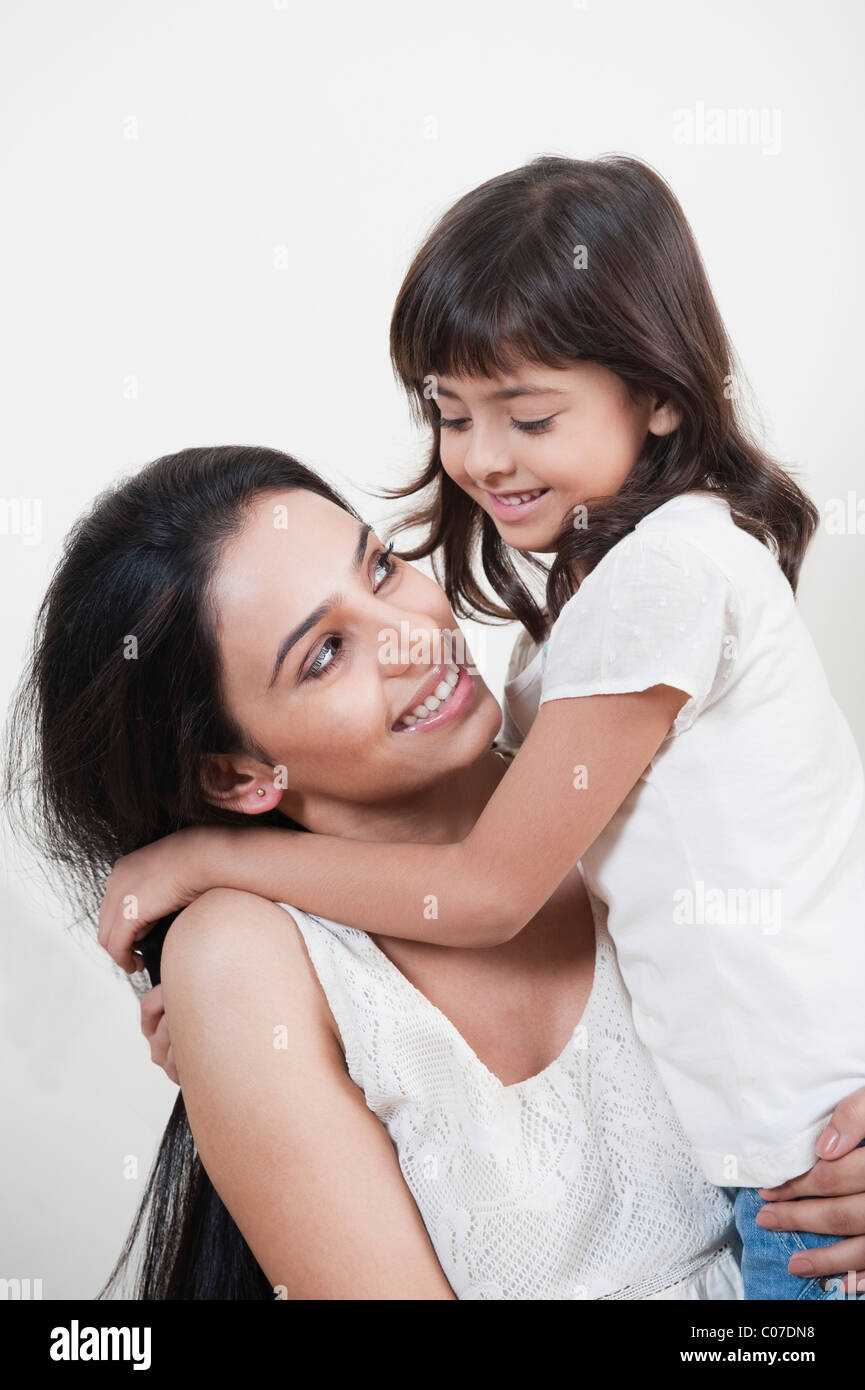 Woman carrying her daughter Stock Photo - Alamy