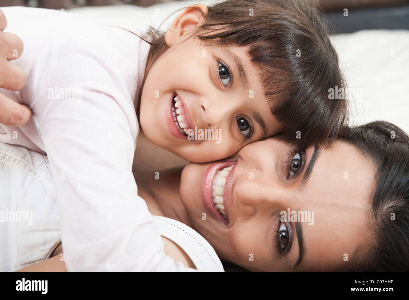 Portrait of a woman smiling with her daughter Stock Photo - Alamy