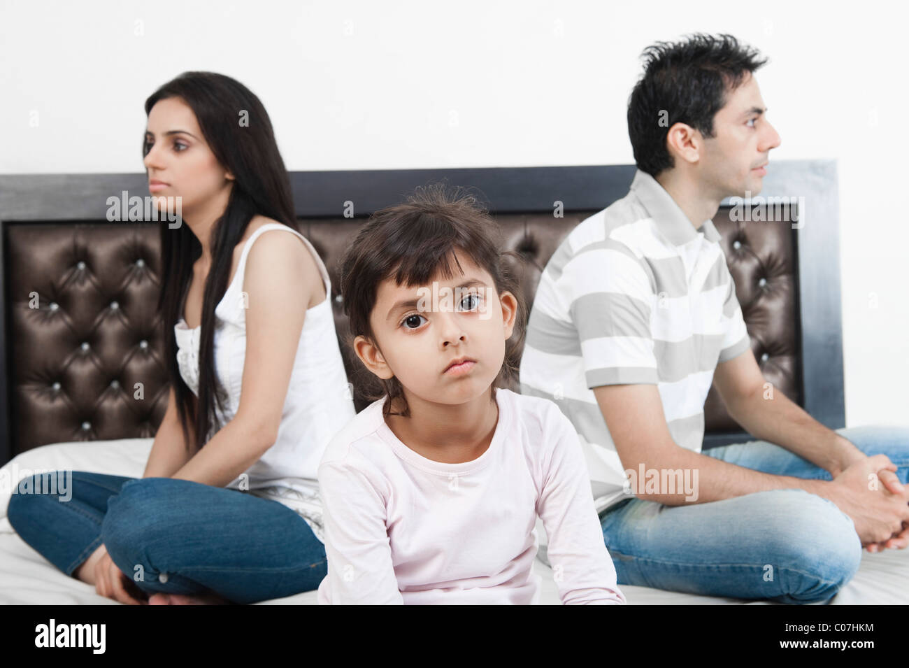 Family sitting back to back Stock Photo - Alamy