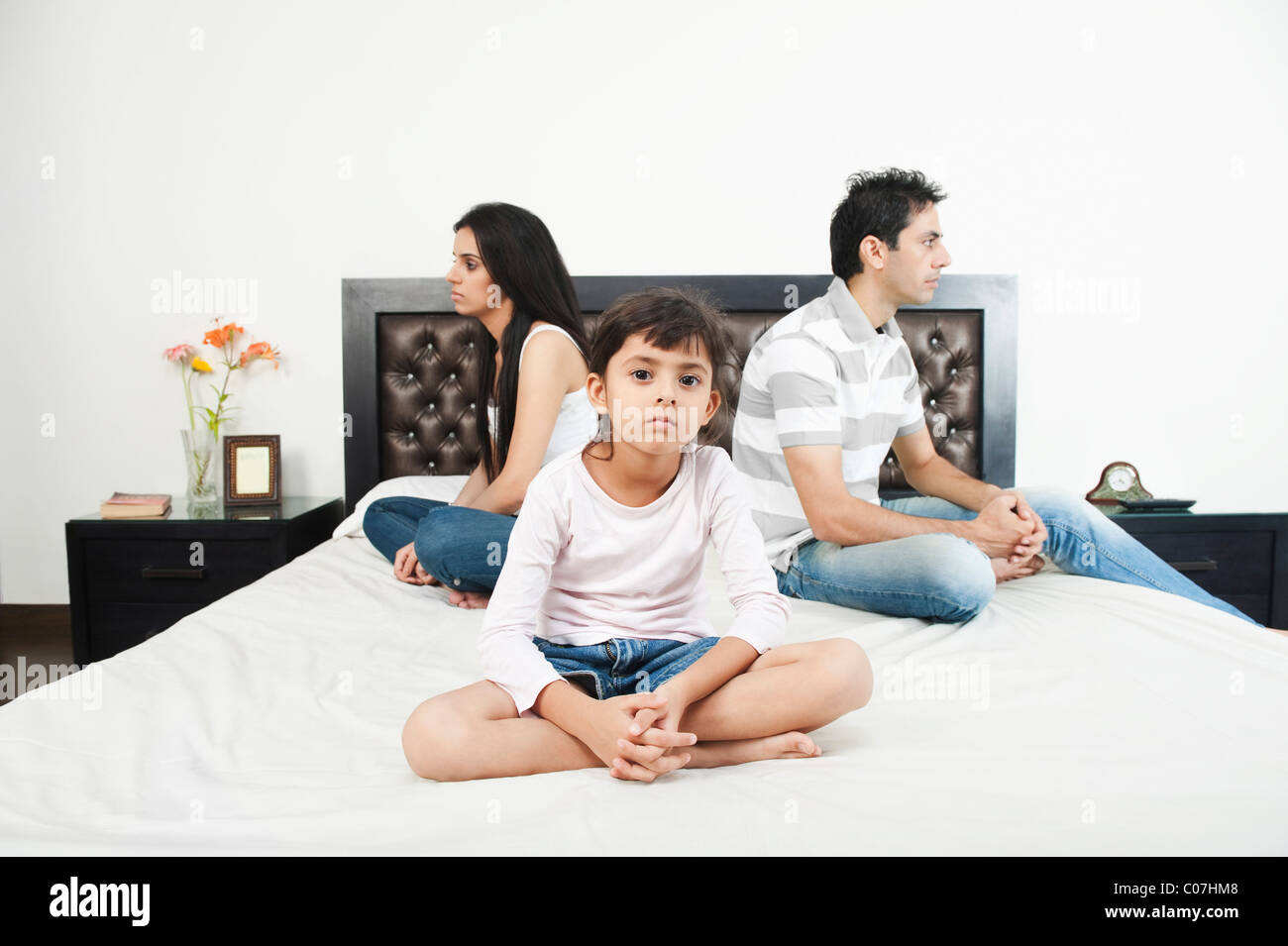Family sitting back to back Stock Photo - Alamy