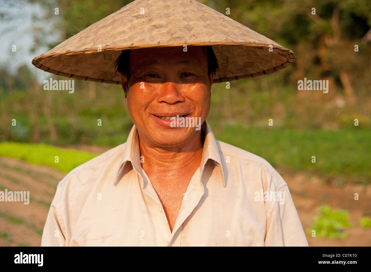 A Lao farmer in his field in Luang Prabang Laos Stock Photo - Alamy