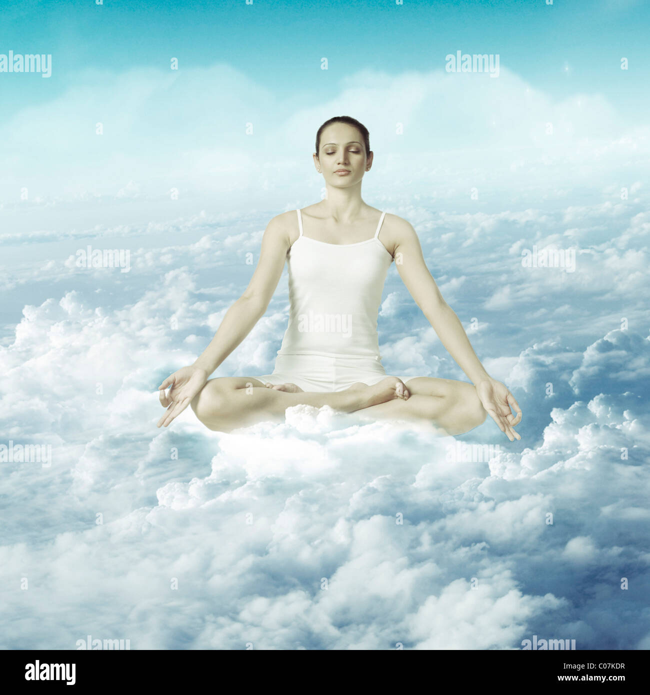 Woman meditating over the clouds Stock Photo - Alamy