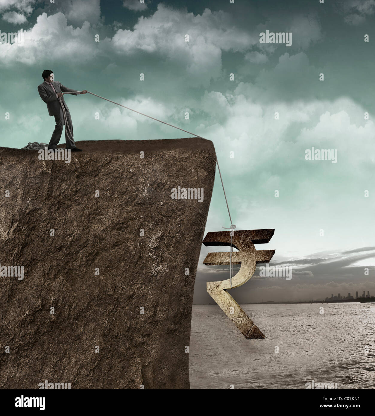 Businessman pulling a rupee symbol from a cliff Stock Photo - Alamy