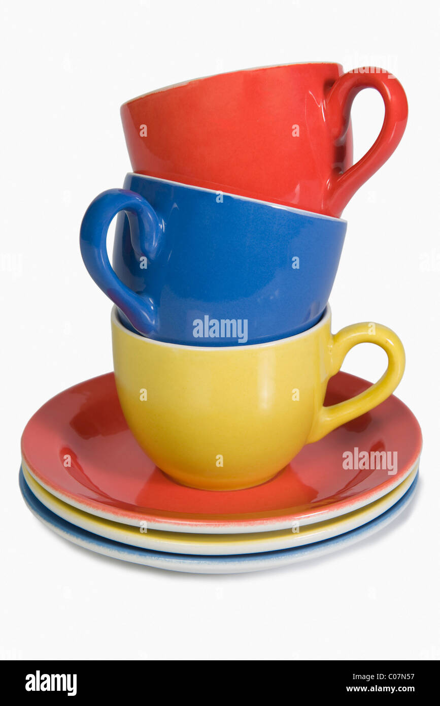 Close-up of a stack of colorful tea cups with saucers Stock Photo - Alamy