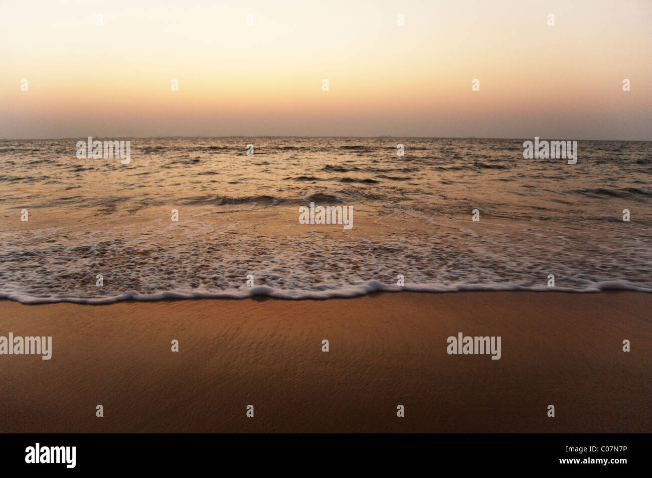 Surf on the beach at dusk, Goa, India Stock Photo - Alamy