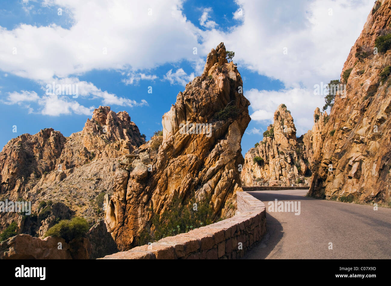 Road through red porphyry rocks, Calanche de Piana, Gulf of Porto ...