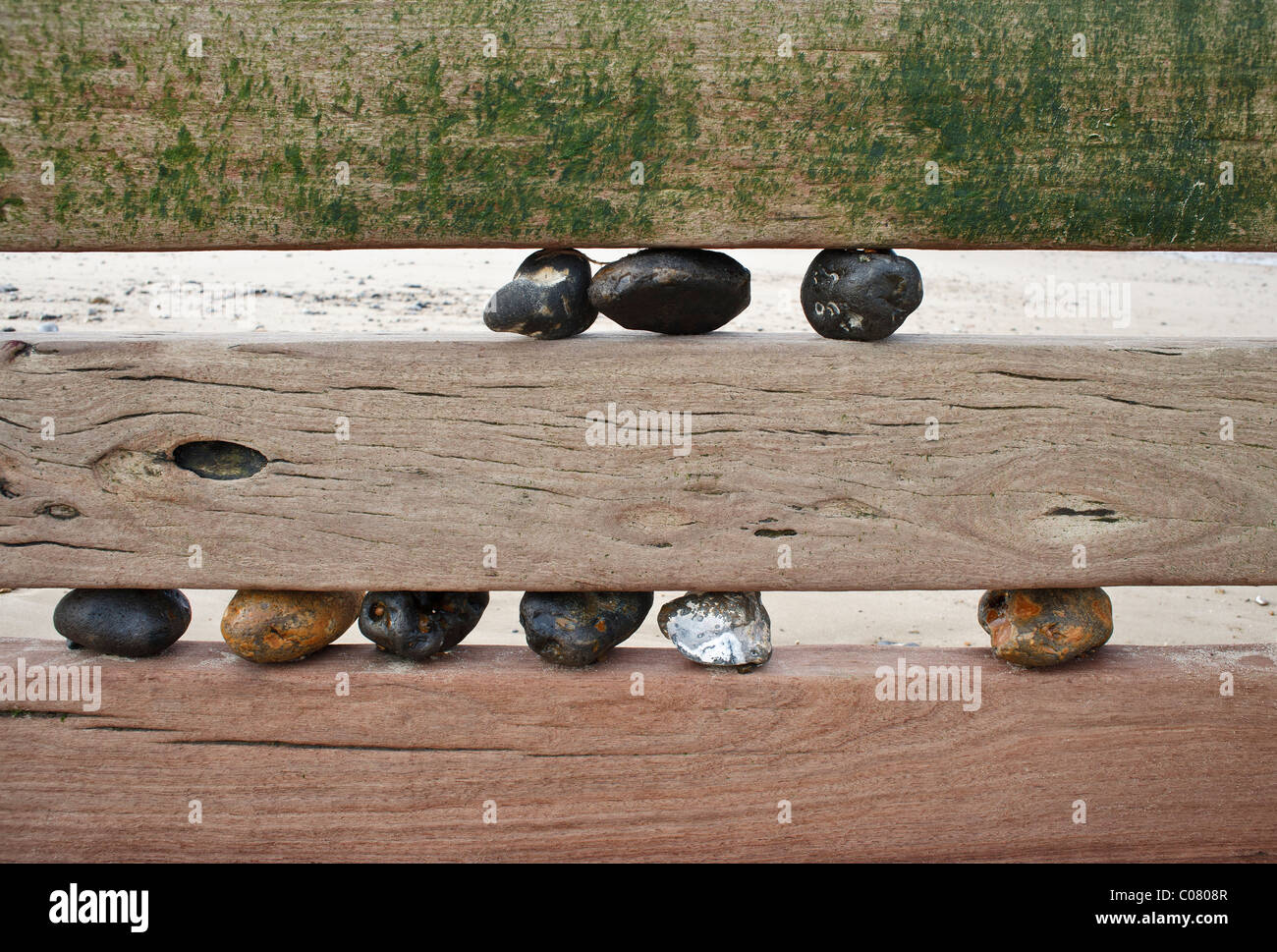 Pebbles trapped in a breakwater "Walcott Beach" "North Norfolk" UK ...
