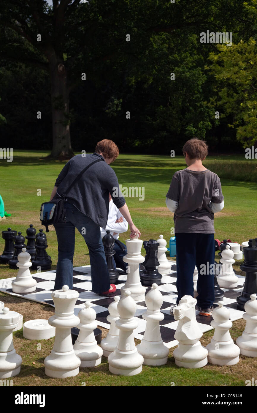 Woman and boy playing with a giant chess set Norfolk East Anglia ...