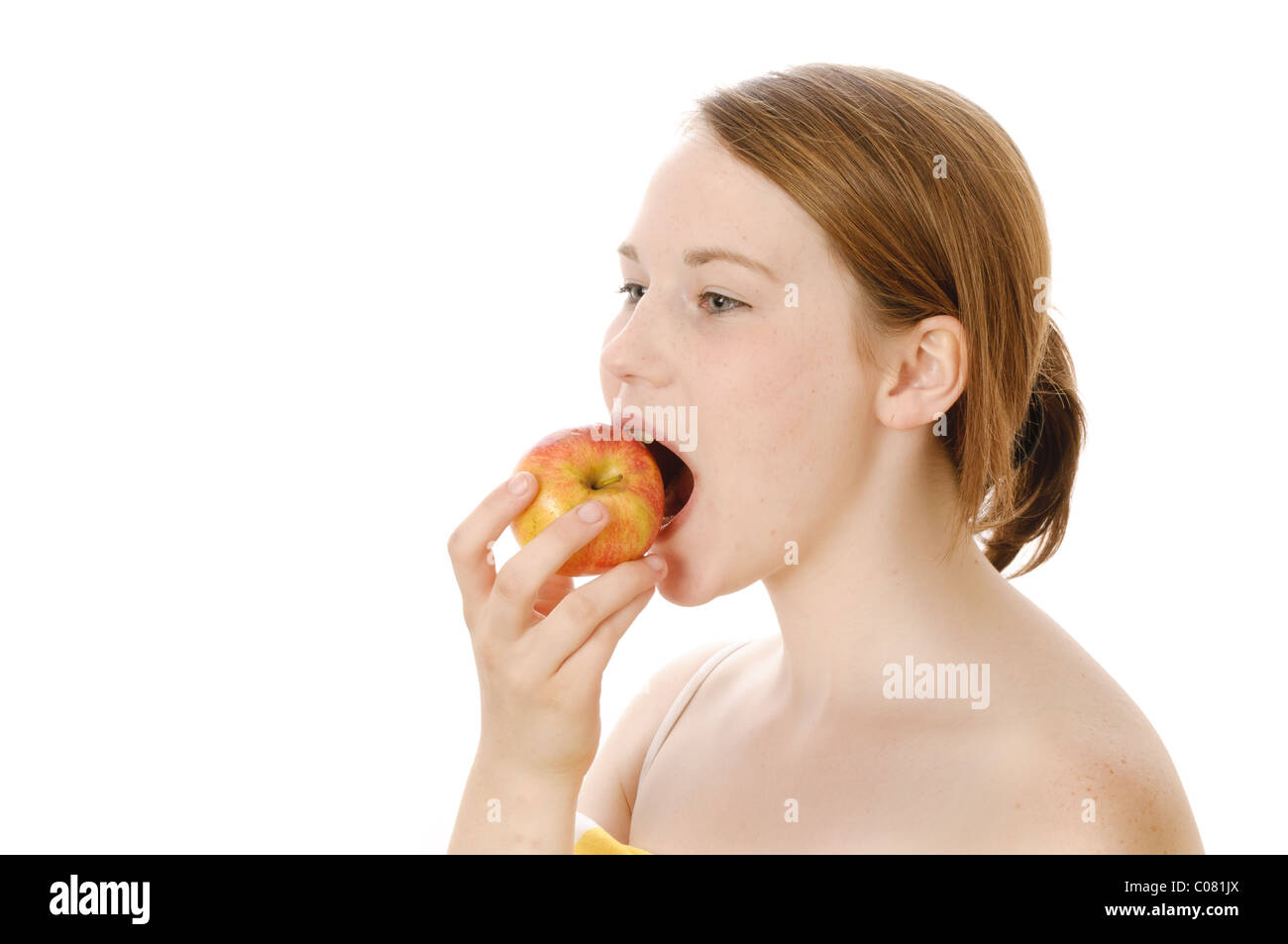 Healthy eating, girl eating fruit Stock Photo - Alamy
